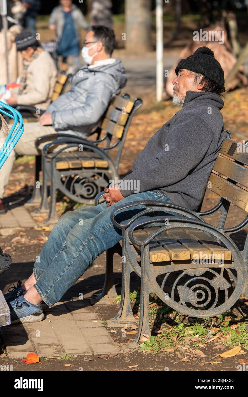 Homeless man sleep on a bench at ueno park in Tokyo, Japan Stock Photo ...