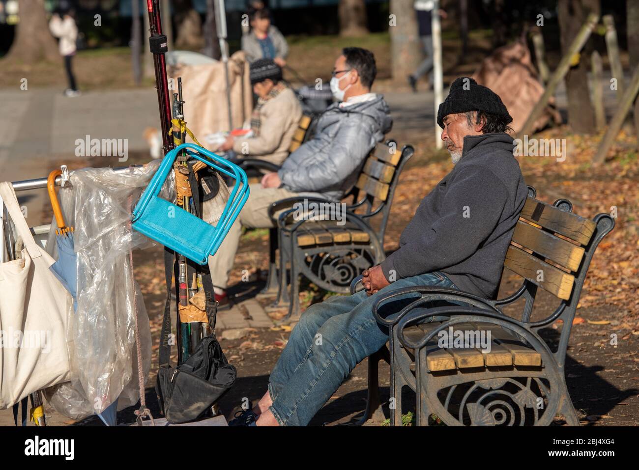 Homeless man sleep on a bench at ueno park in Tokyo, Japan Stock Photo ...