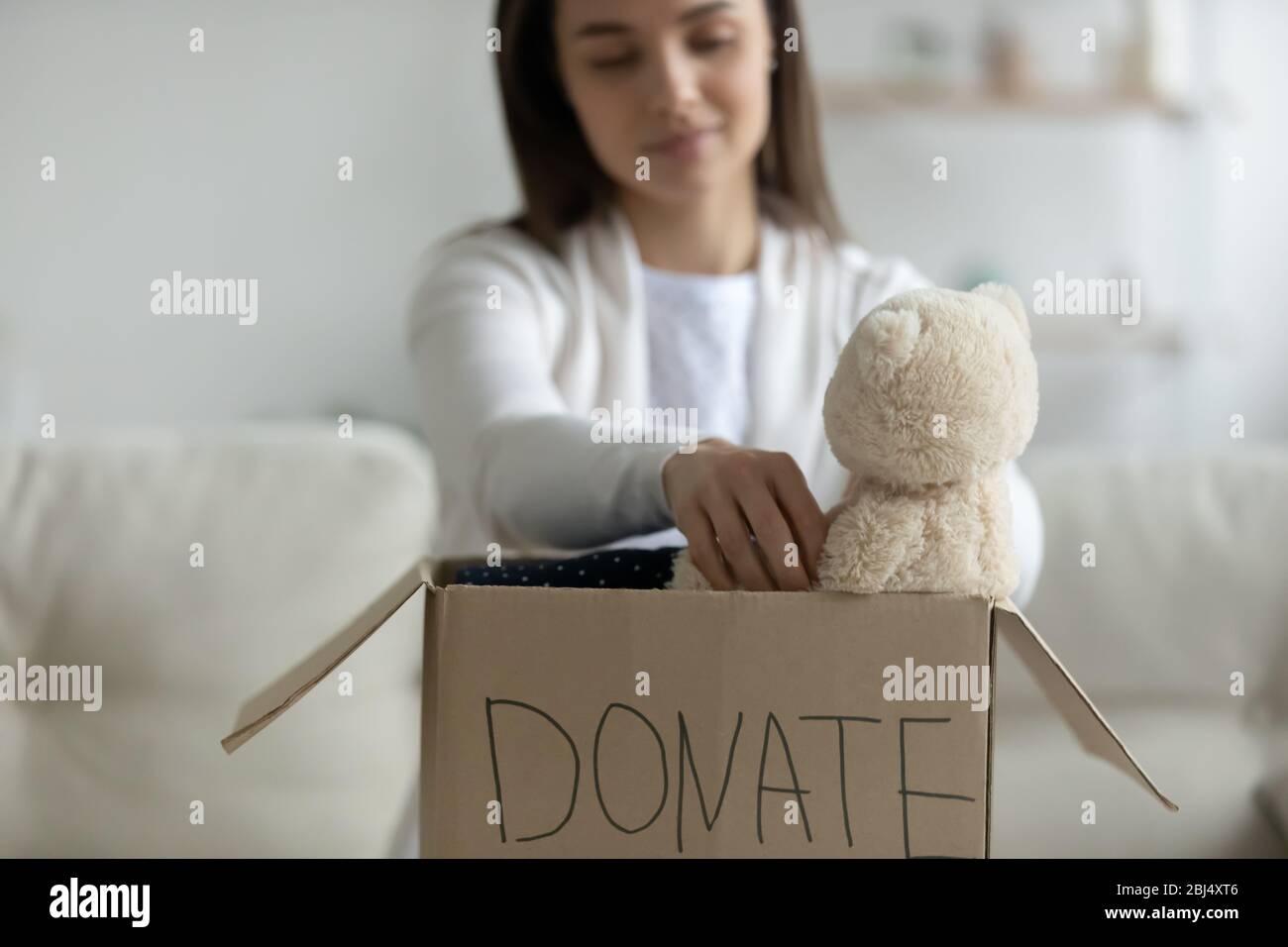 Young woman gather things for donation or charity Stock Photo - Alamy