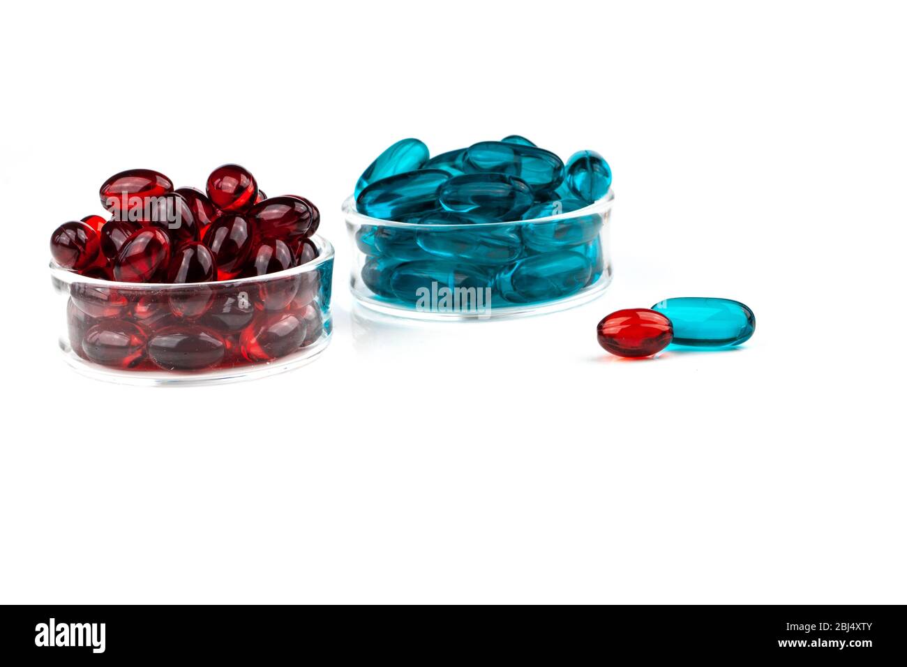 A mix of multicolored medical soft gel capsules on a white background ...