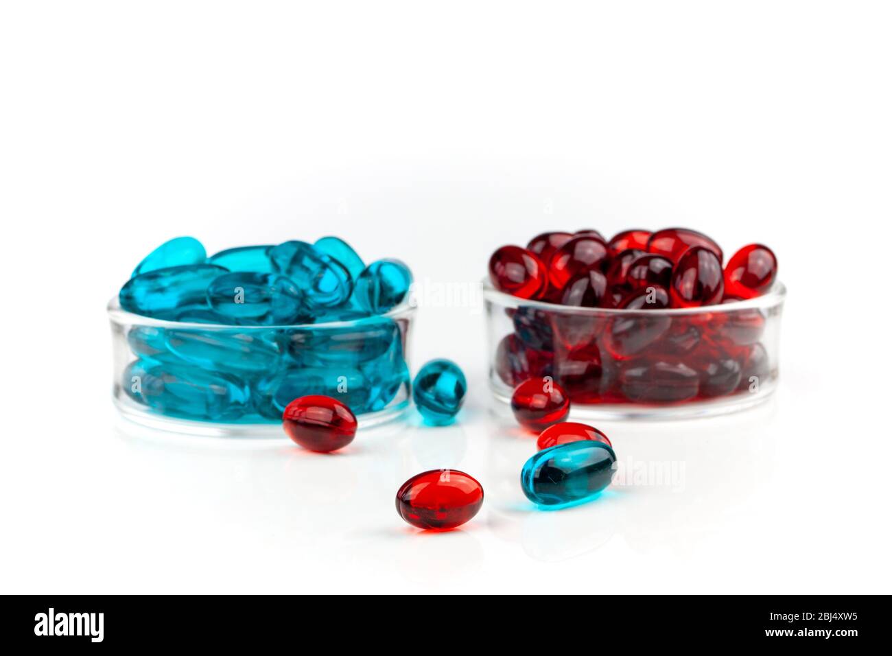 A mix of multicolored medical soft gel capsules on a white background ...