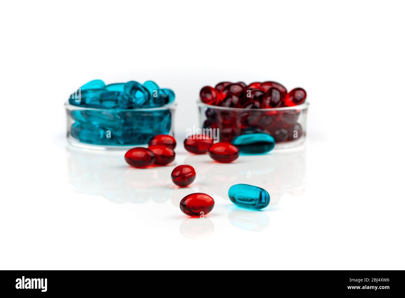 A mix of multicolored medical soft gel capsules on a white background ...