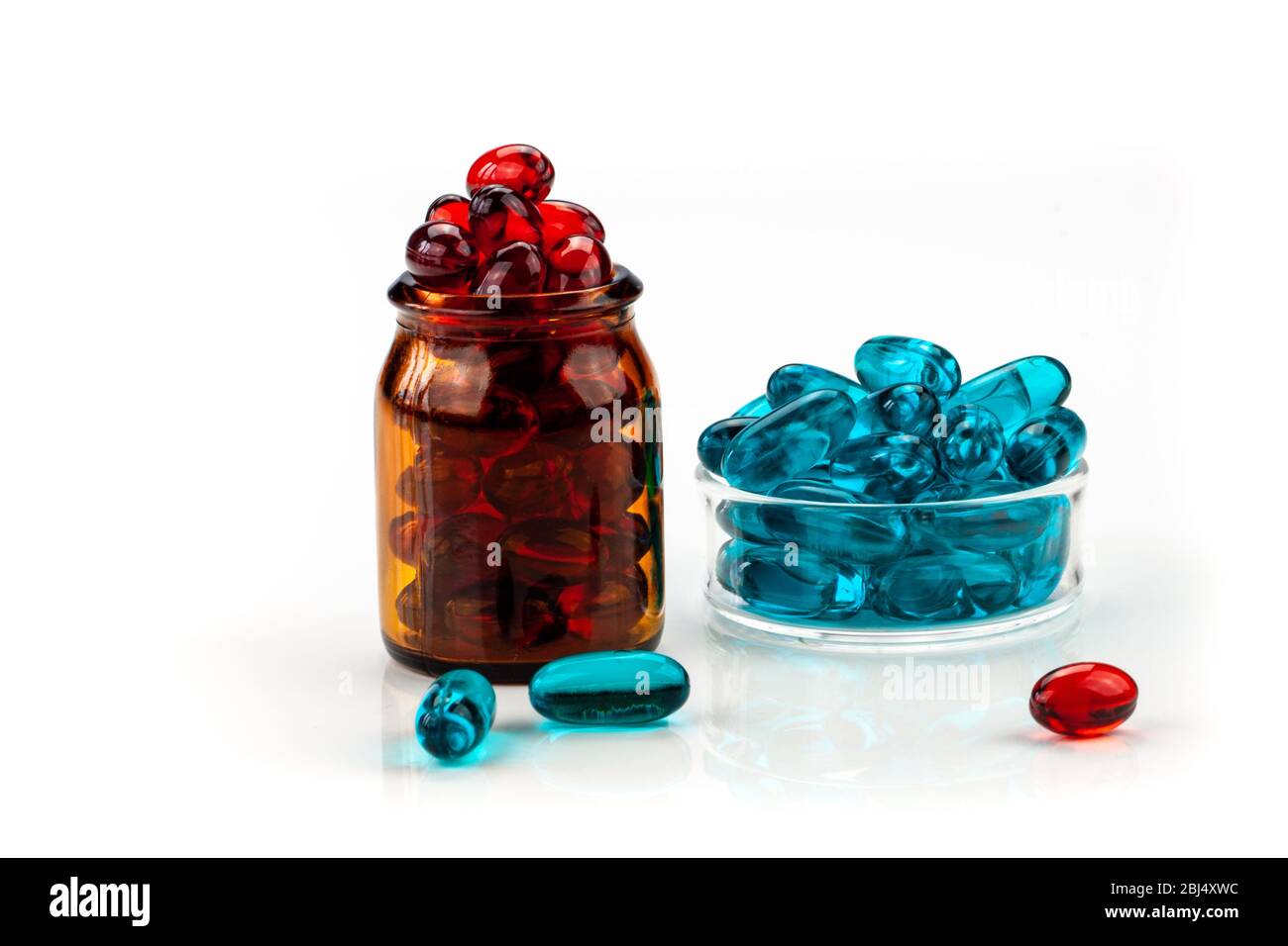 A mix of multicolored medical soft gel capsules on a white background ...