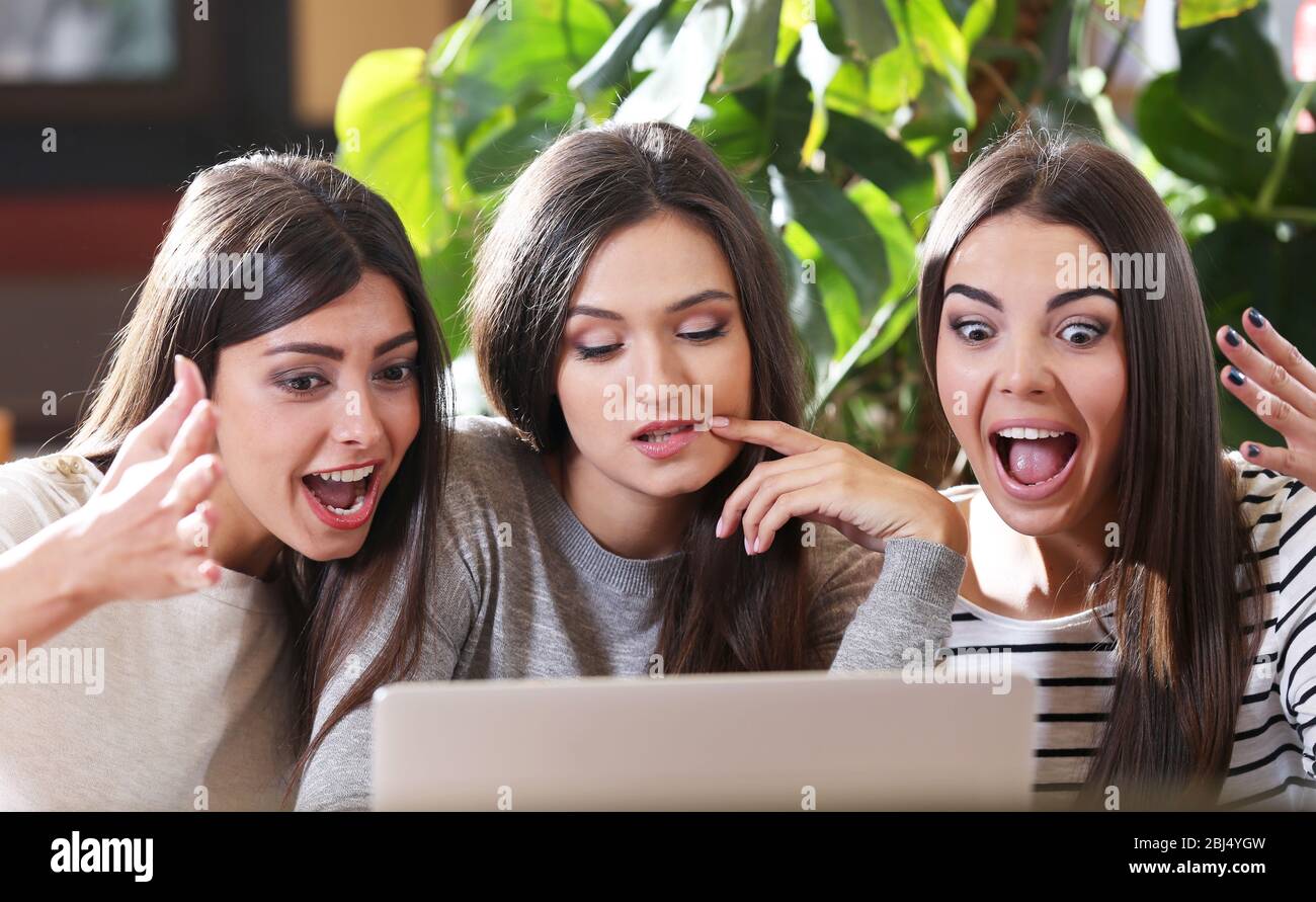 Best friends with laptop together sitting in cafe, close up Stock Photo ...