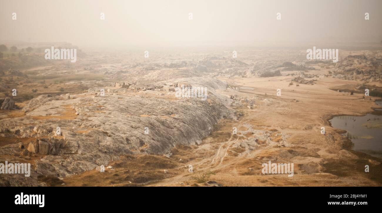 The dusty landscape of Rajasthan in India seen from a moving train ...
