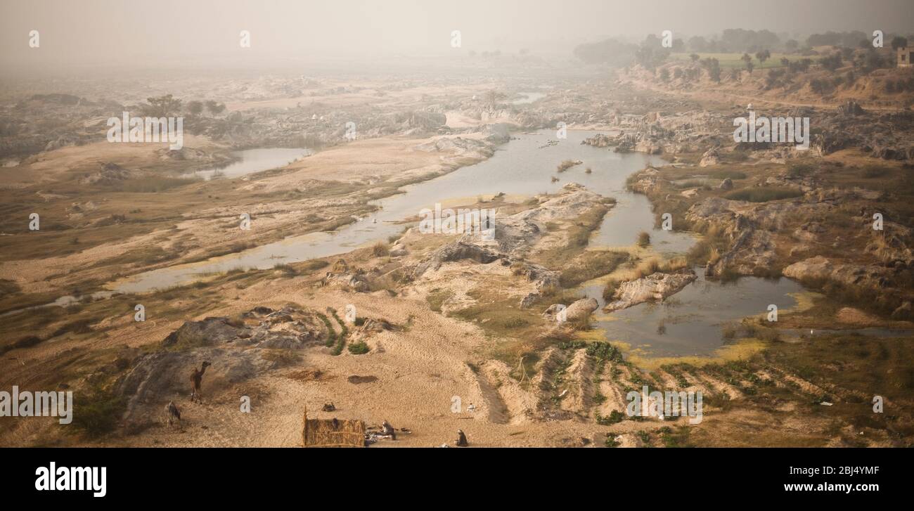 The dusty landscape of Rajasthan in India seen from a moving train ...
