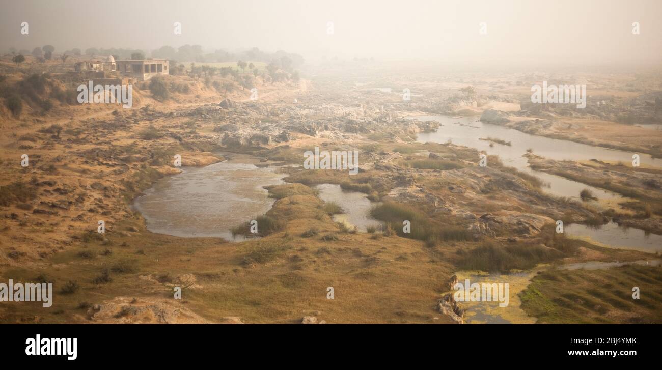 The dusty landscape of Rajasthan in India seen from a moving train ...