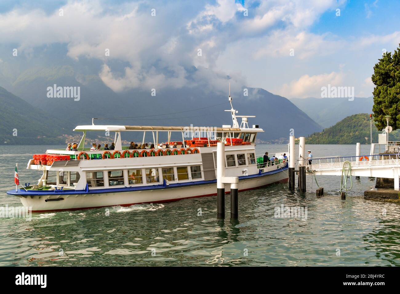 TREMEZZO, LAKE COMO - JUNE 2019: Small passenger boat at the ferry stop ...