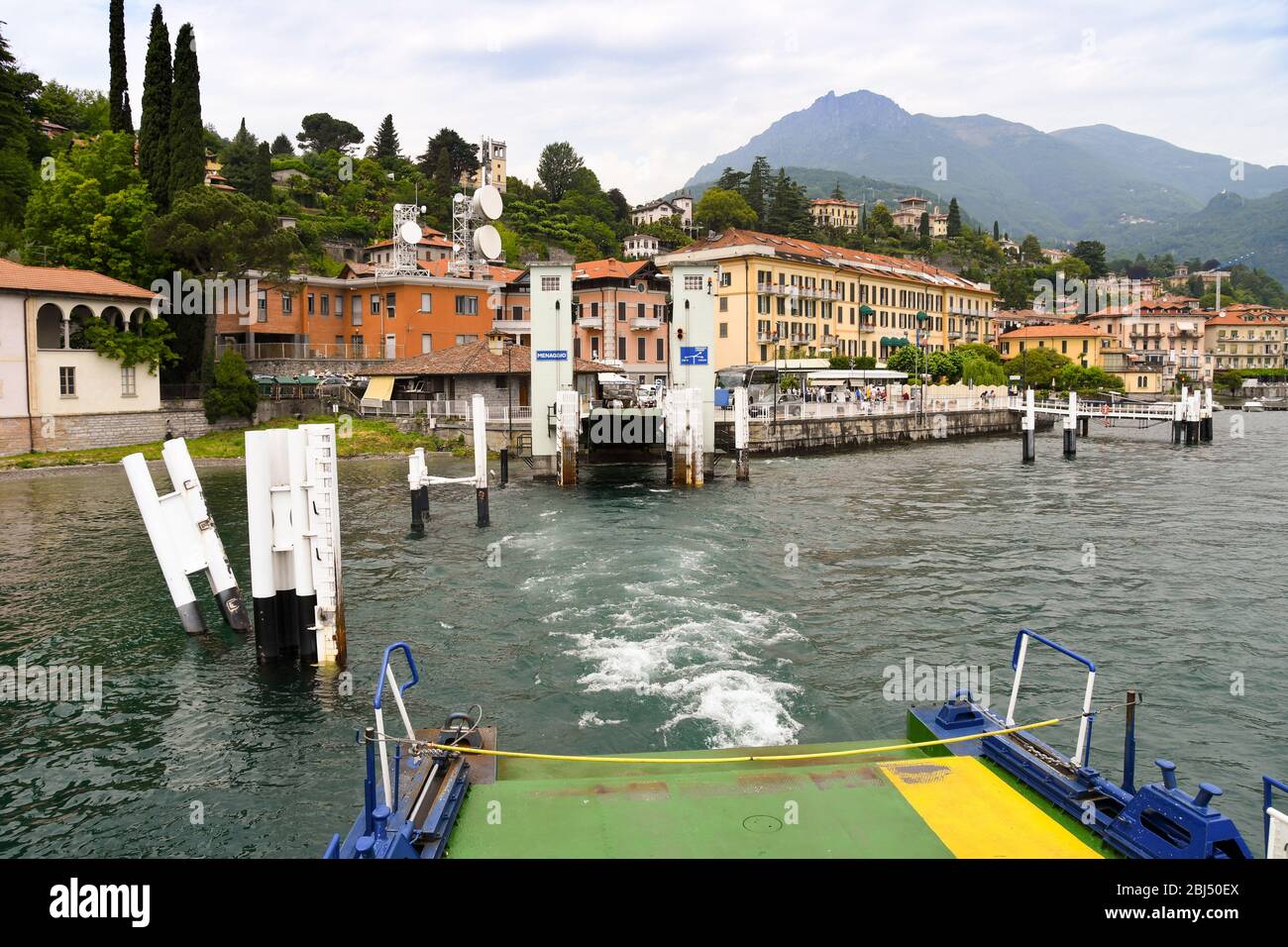 MENAGGIO, LAKE COMO - JUNE 2019: View of the dock as a ferry leaves the ...