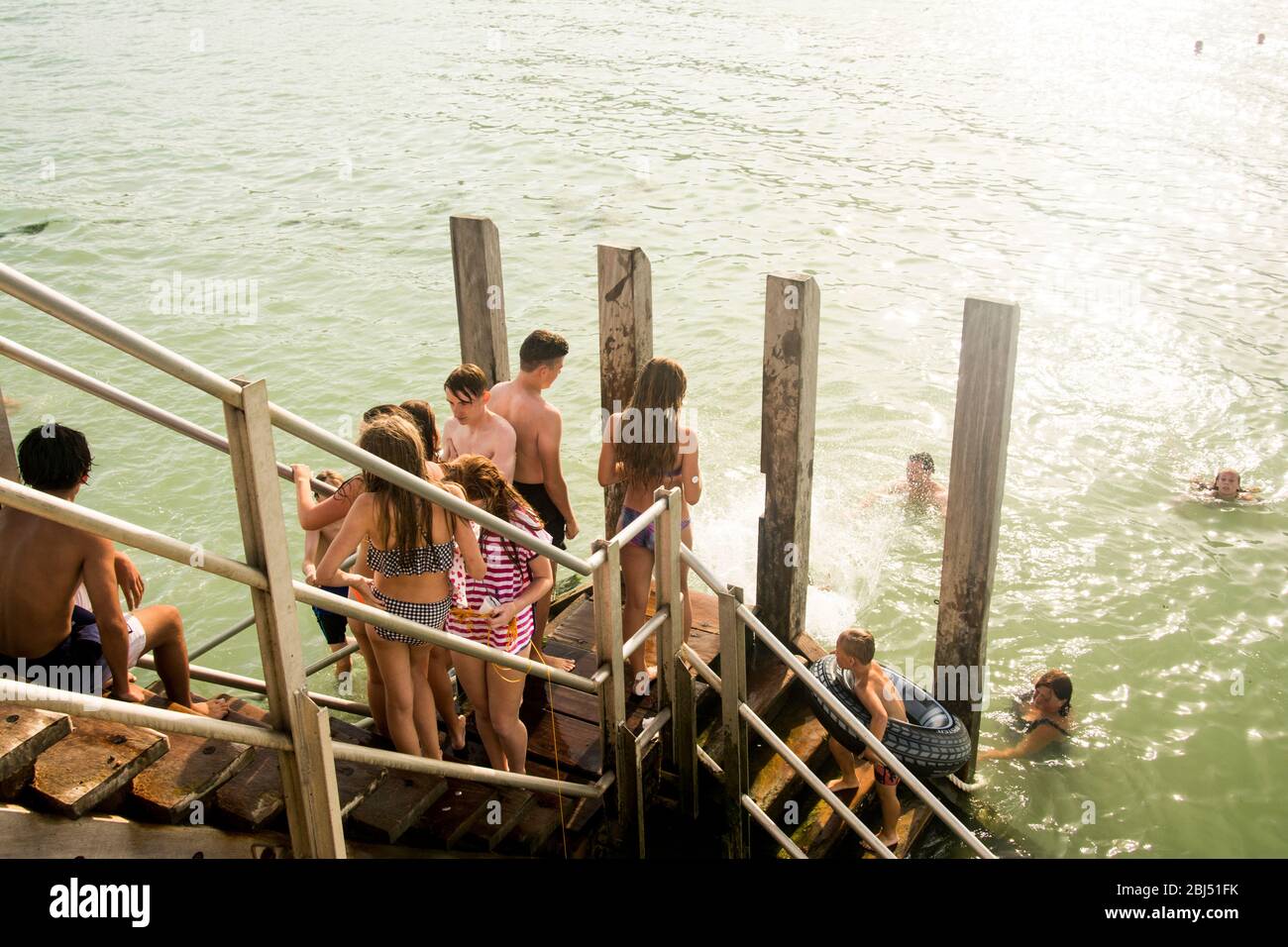 Teenagers waiting to swim during an English heatwave Stock Photo - Alamy
