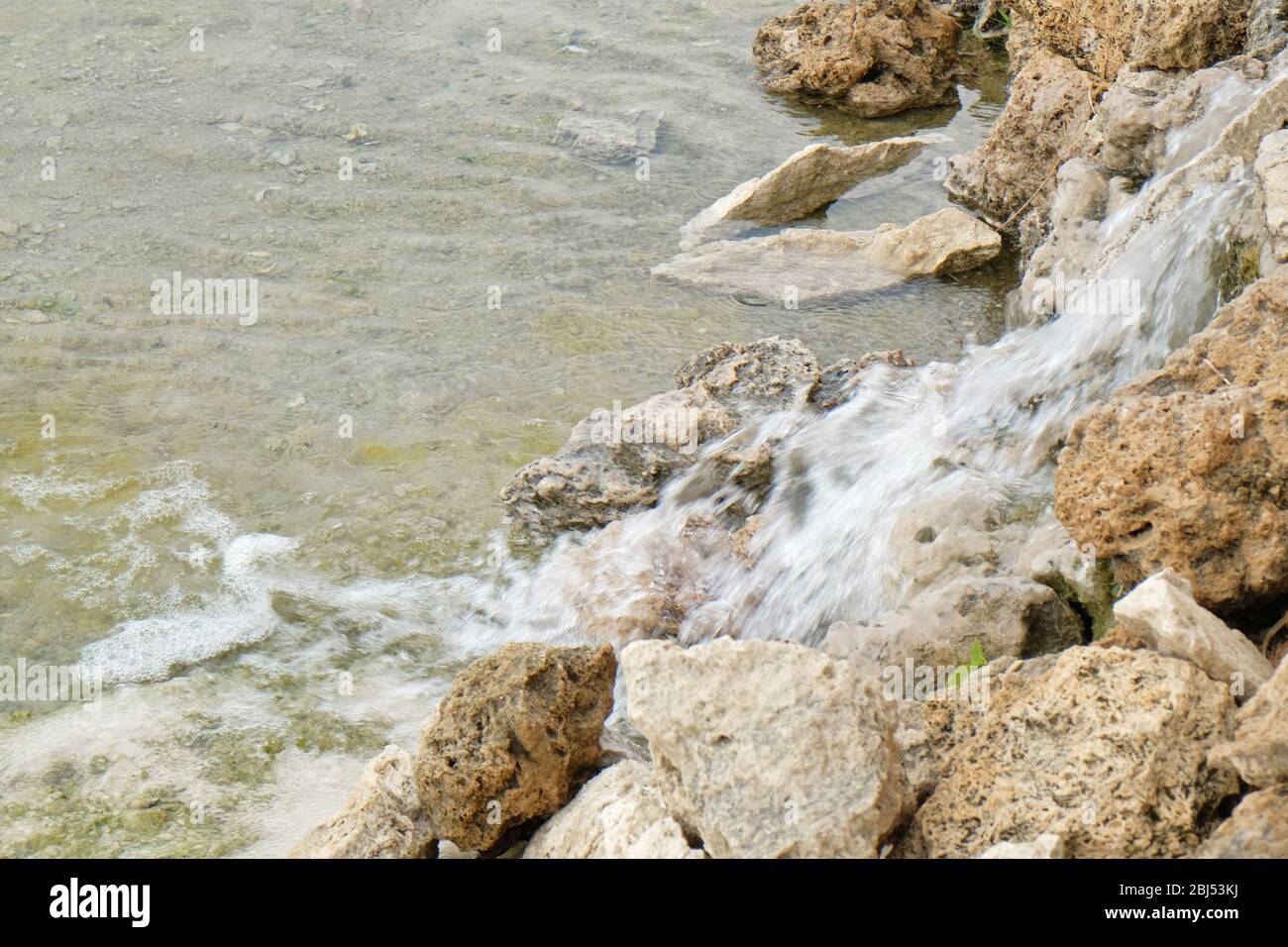 Water flowing from the stones Stock Photo - Alamy