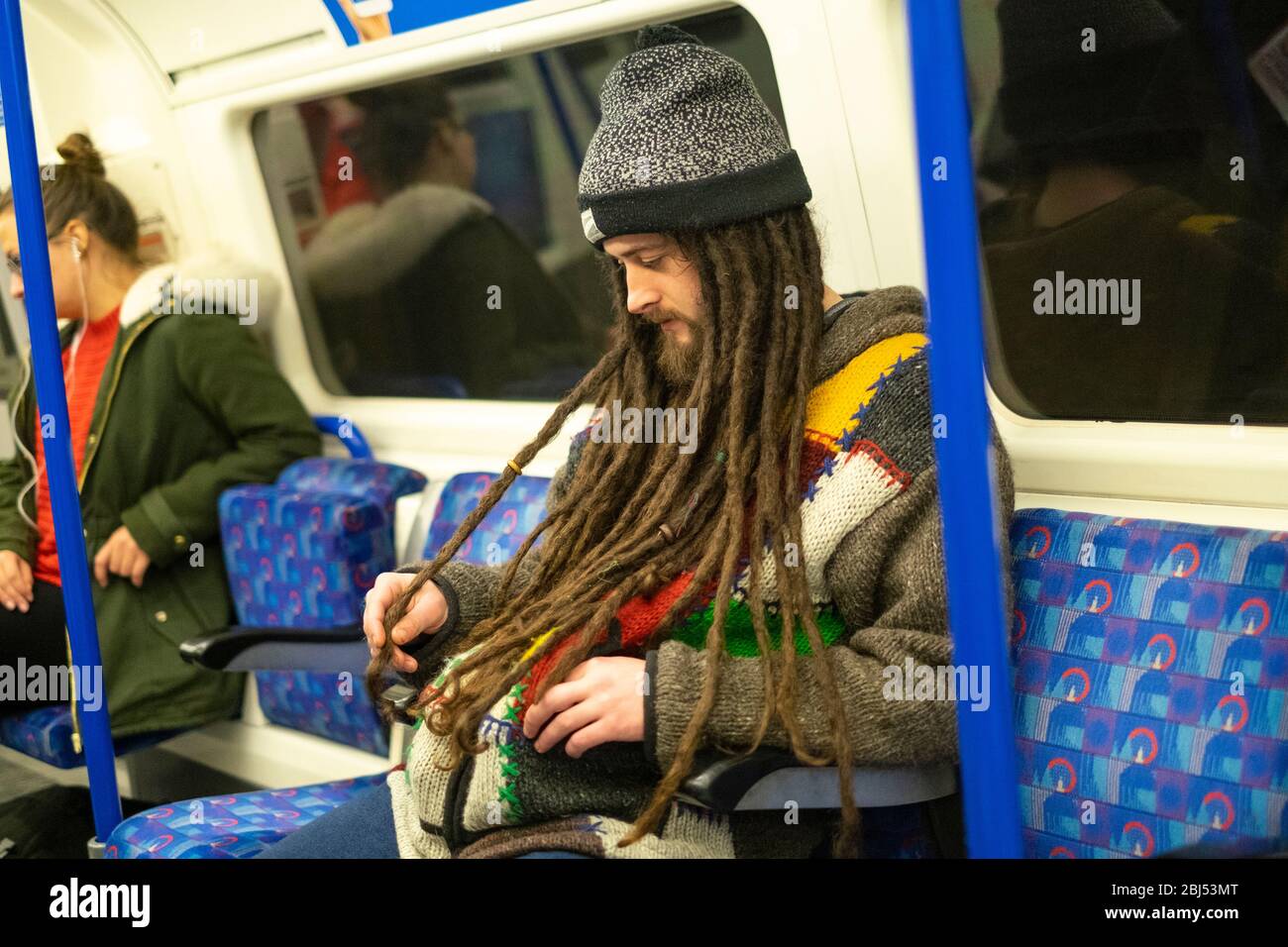 Portrait of man with dreadlocks and beanie on the London Underground ...