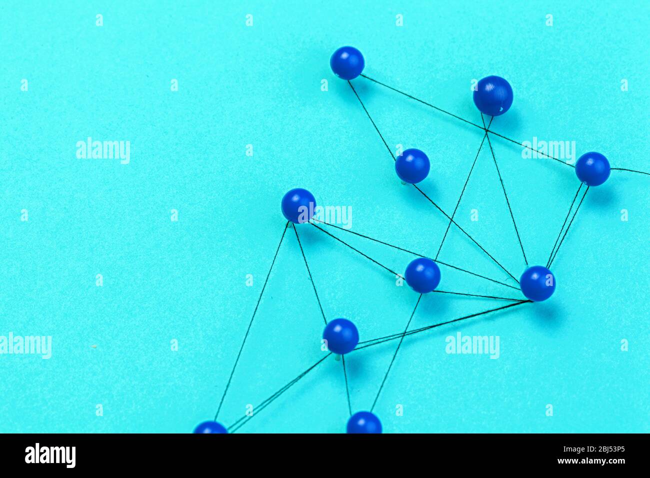 pins connected creating a network. Close up Stock Photo - Alamy
