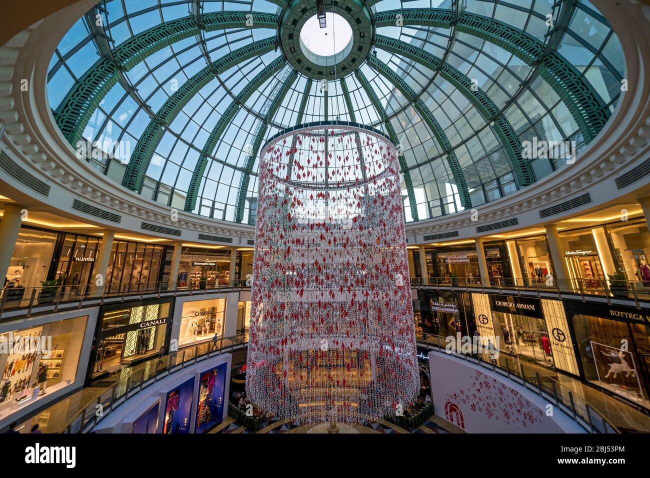 Holiday decorations stream from the towering dome of the Mall of the ...