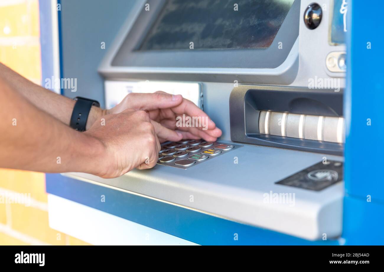 Entering a credit card pin on an ATM keyboard Stock Photo - Alamy
