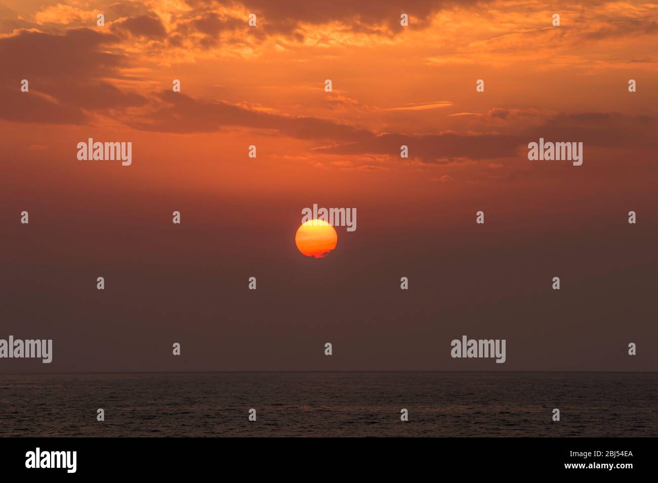 Sunset sky with the shining sun Stock Photo - Alamy