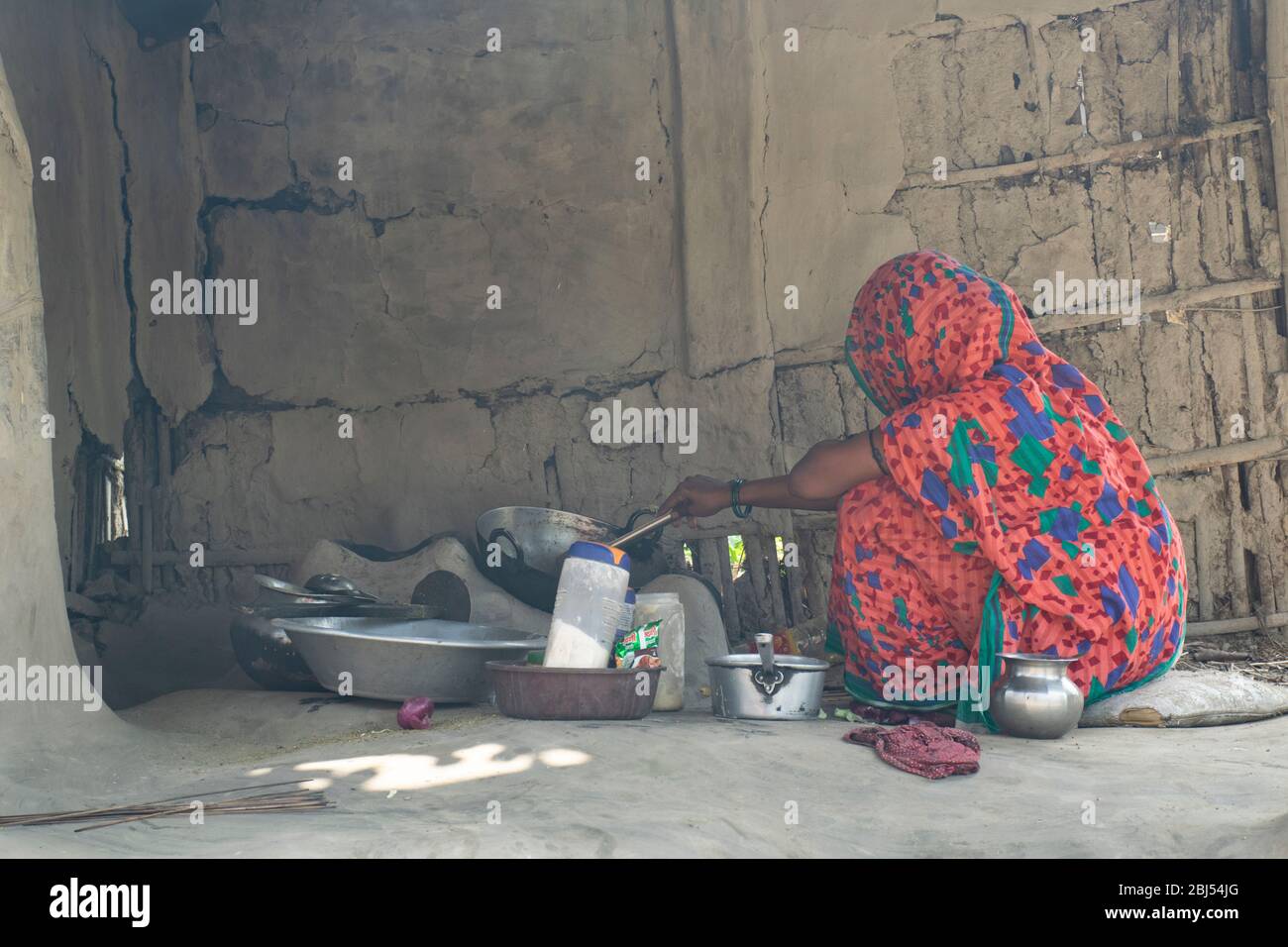 Rural Woman cooking food in the Kitchen using firewood stove Stock ...
