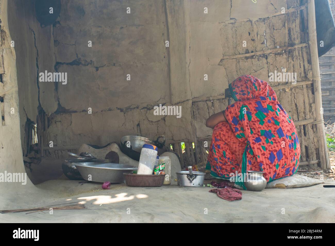 Rural Woman cooking food in the Kitchen using firewood stove Stock ...