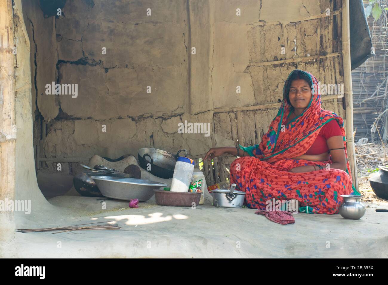 Rural Woman cooking food in the Kitchen using firewood stove Stock ...