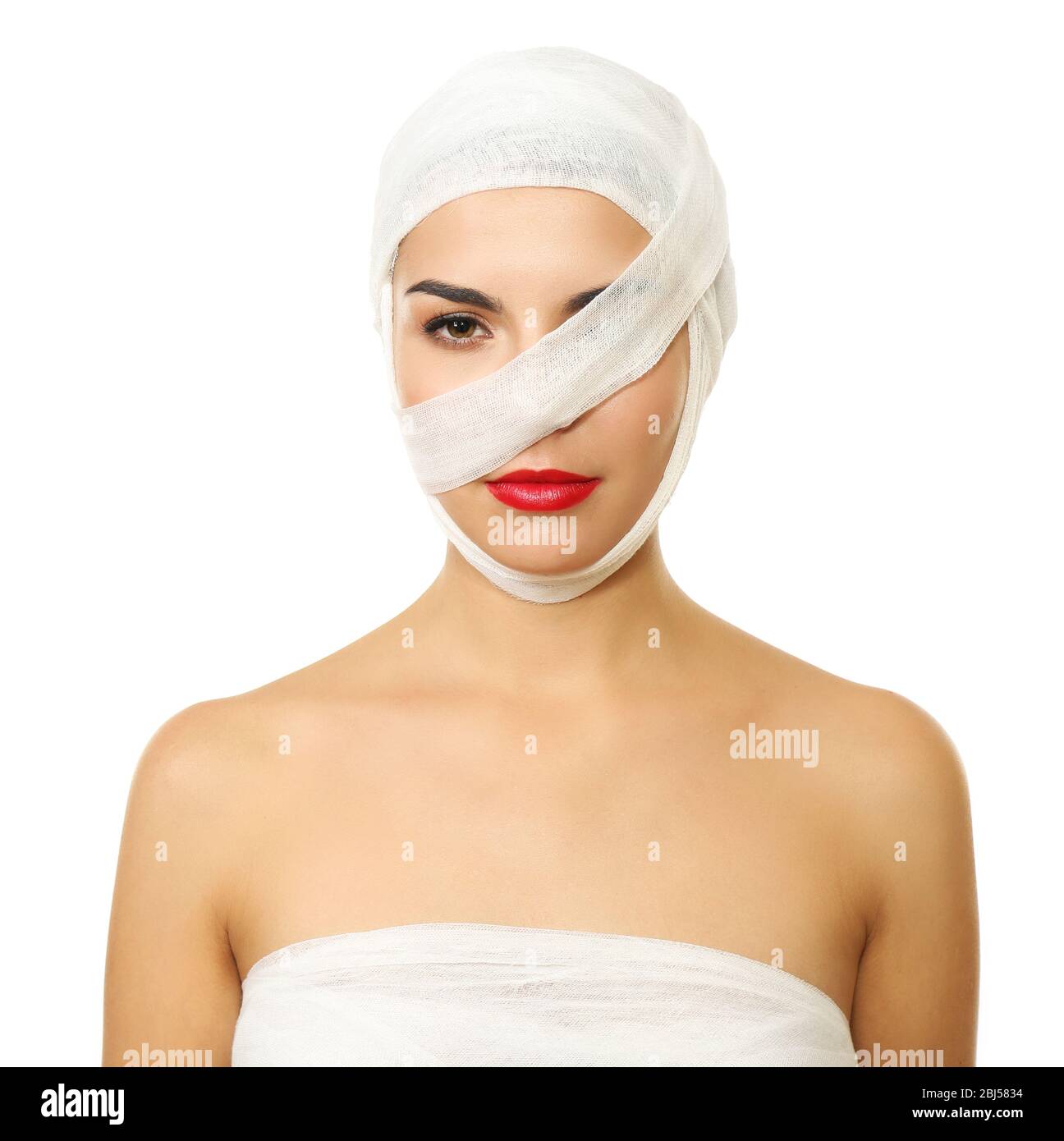 Young playful woman with a gauze bandage on her head and chest, on ...