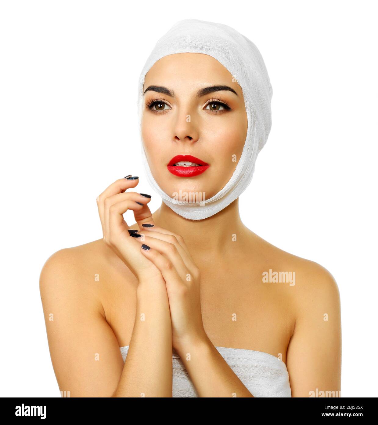 Young beautiful woman with a gauze bandage on her head and chest ...