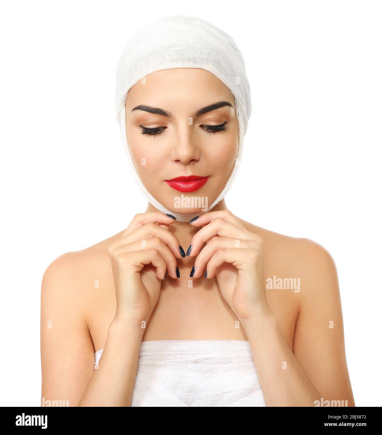 Young beautiful woman with a gauze bandage on her head and chest ...