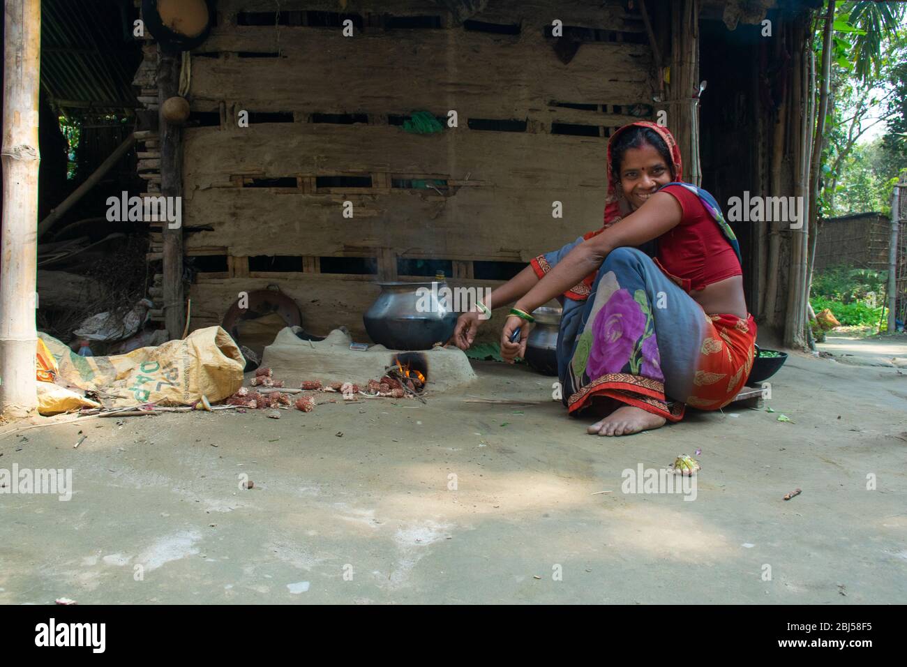 Rural Woman cooking food in the Kitchen using firewood stove Stock ...
