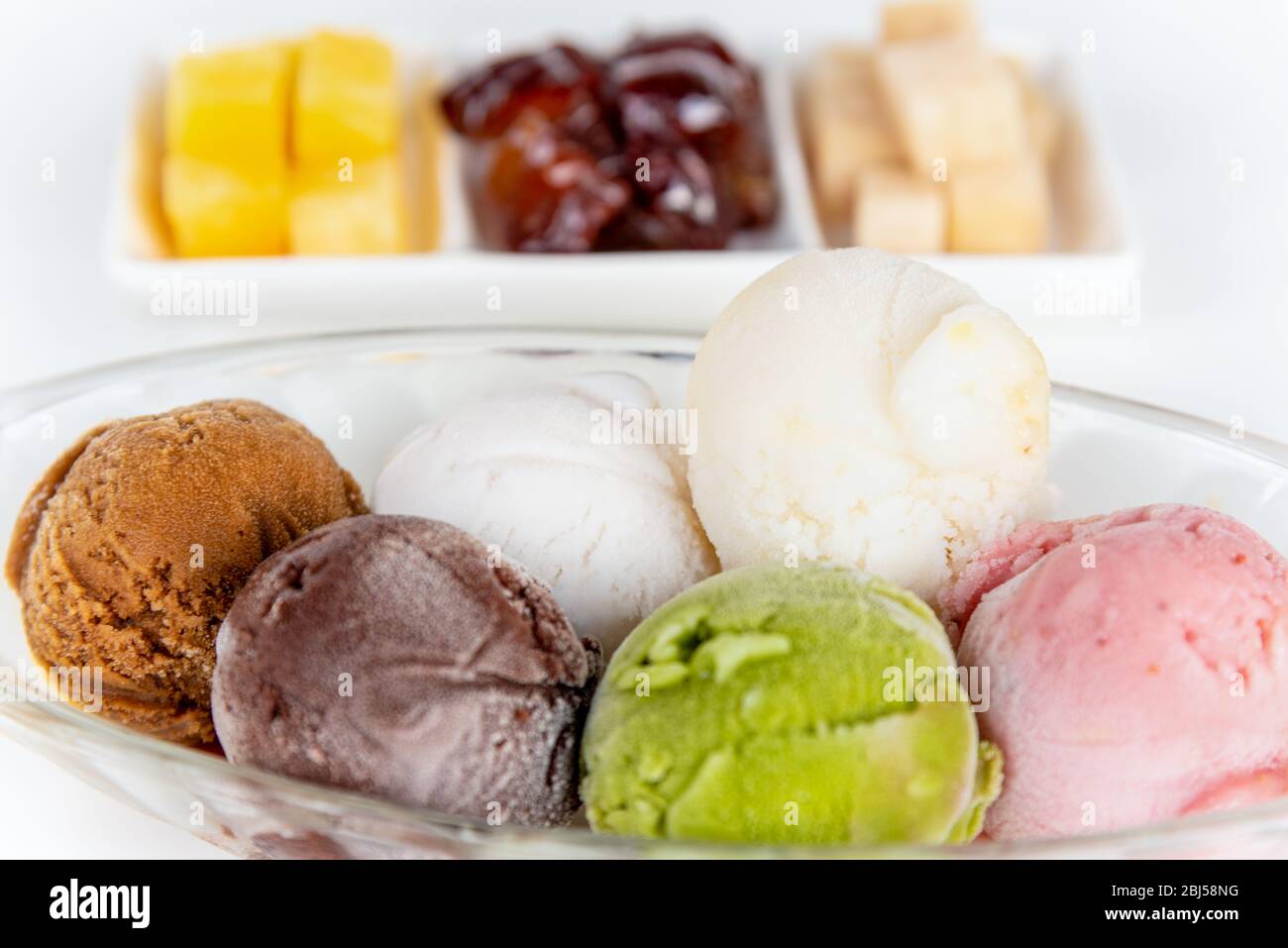 Closeup side view multi colored ice cream in a clear dish and sweet ...