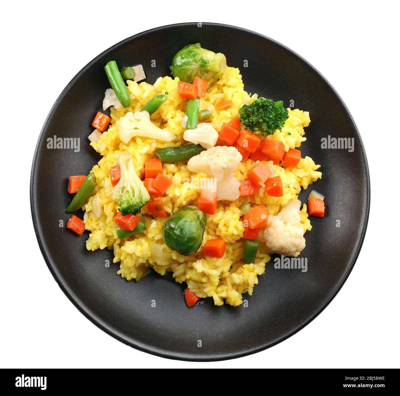 Rice with vegetables on black plate isolated on white Stock Photo - Alamy