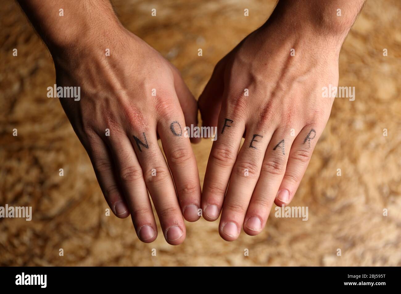 Tattoo inscriptions on male fingers drawn with marker Stock Photo - Alamy