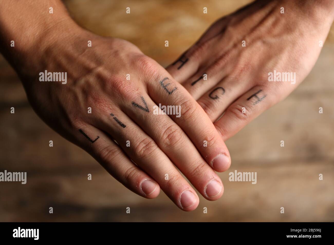 Tattoo inscriptions on male fingers drawn with marker Stock Photo - Alamy