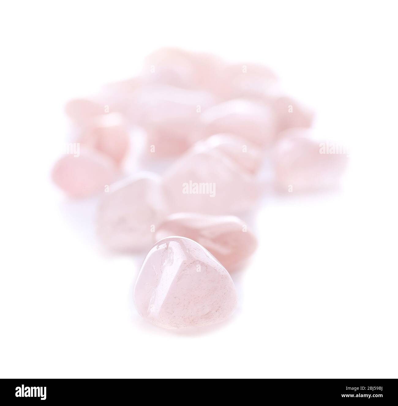 Pink quartz pile isolated on white background Stock Photo - Alamy