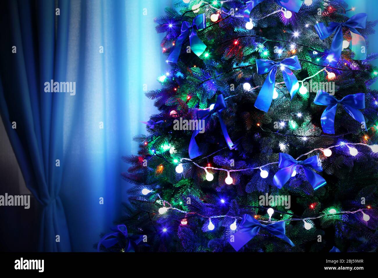 Christmas tree in a room on window background Stock Photo - Alamy