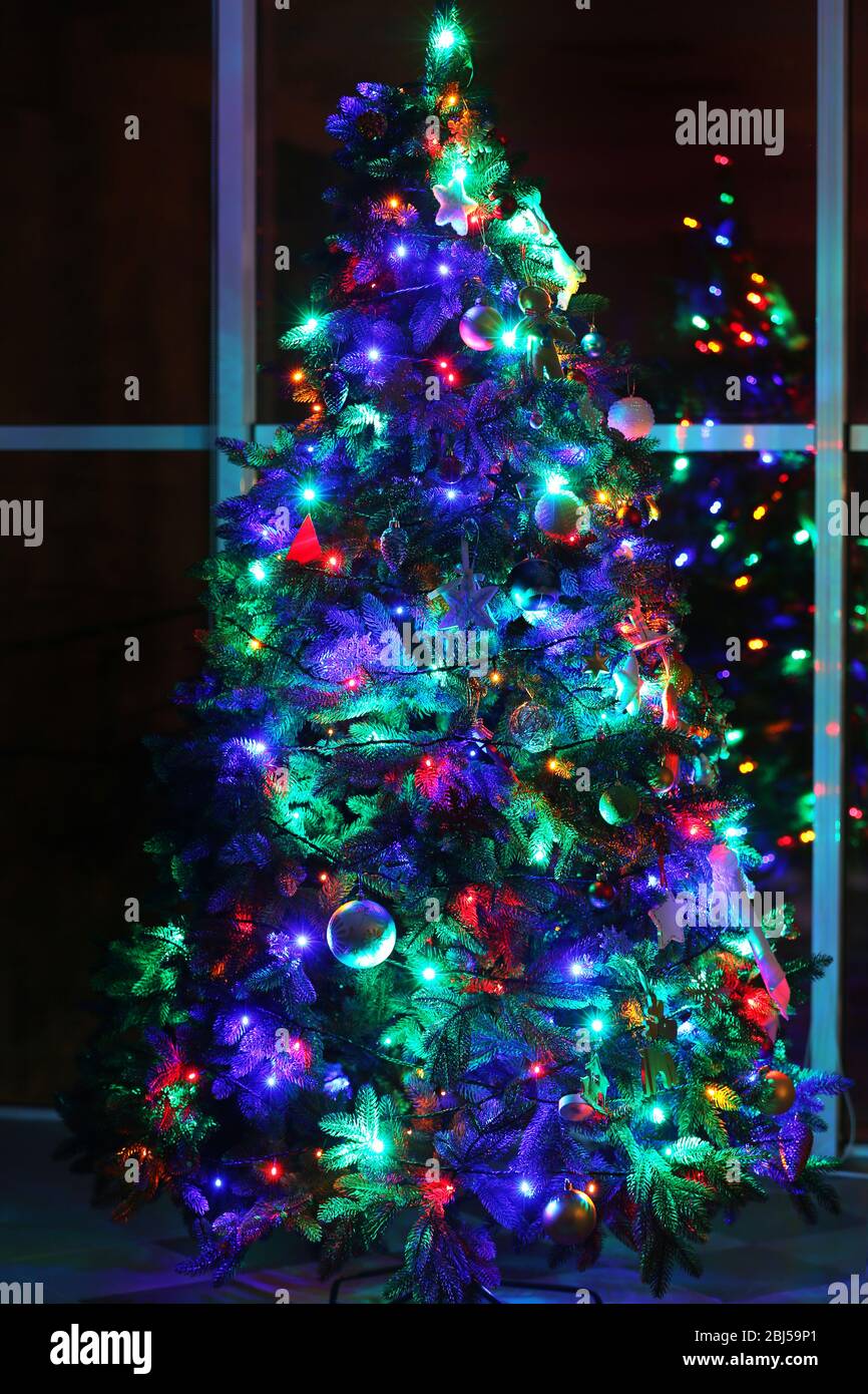 Christmas tree on window background Stock Photo - Alamy