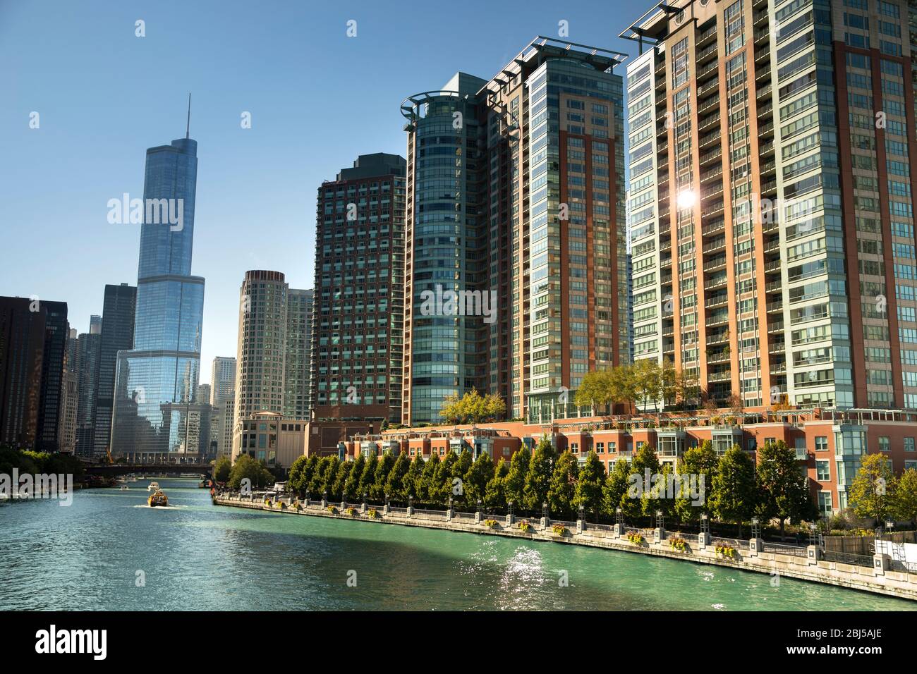 Boats float down the Chicago River skyline in downtown Chicago Illinois ...