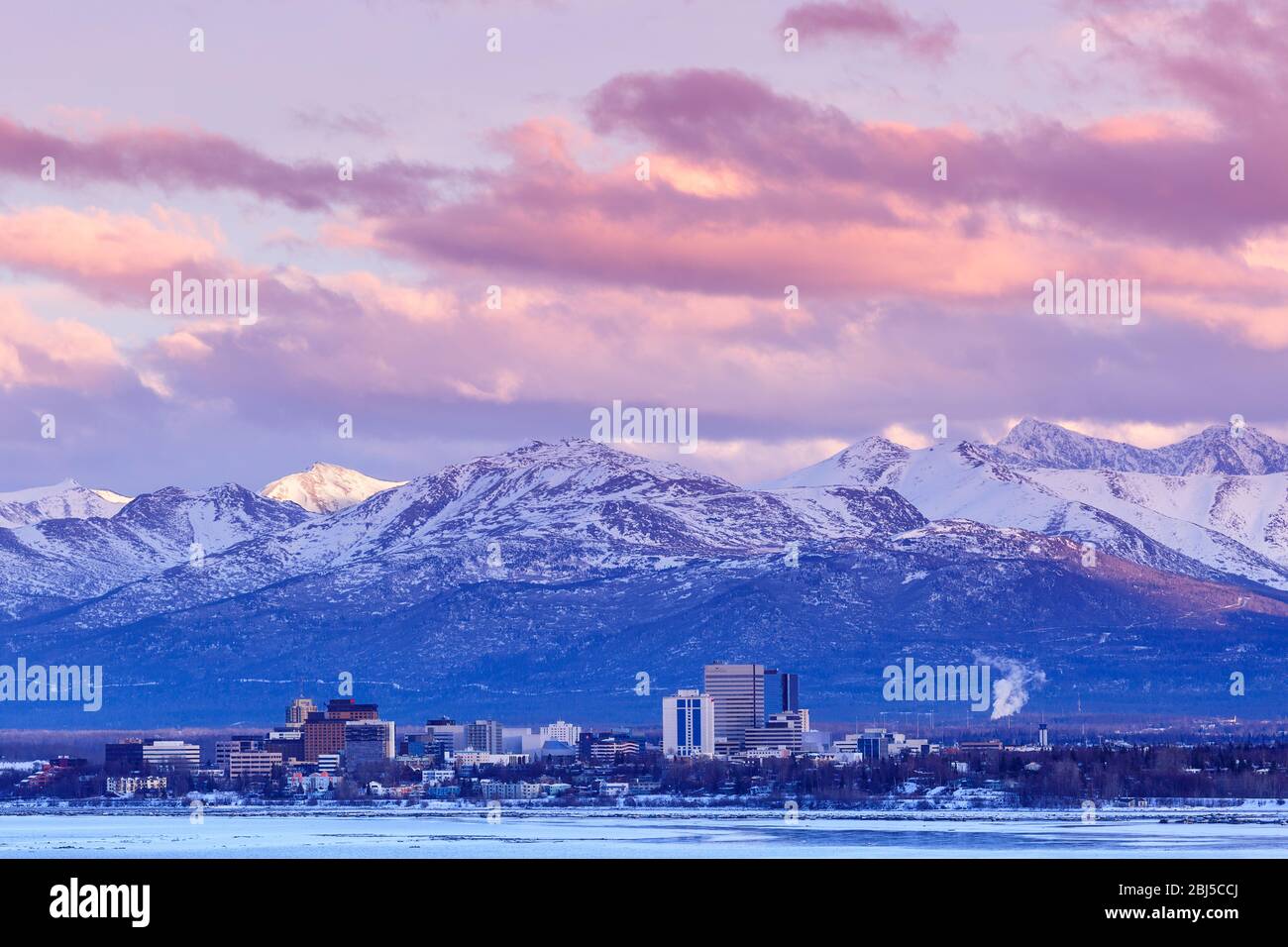 Anchorage Alaska skyline with Chugach mountains in background at sunset ...