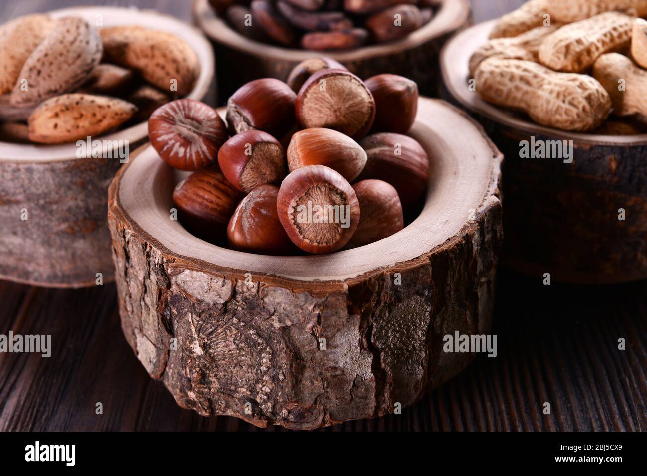 Assortment of tasty nuts on wooden background Stock Photo - Alamy