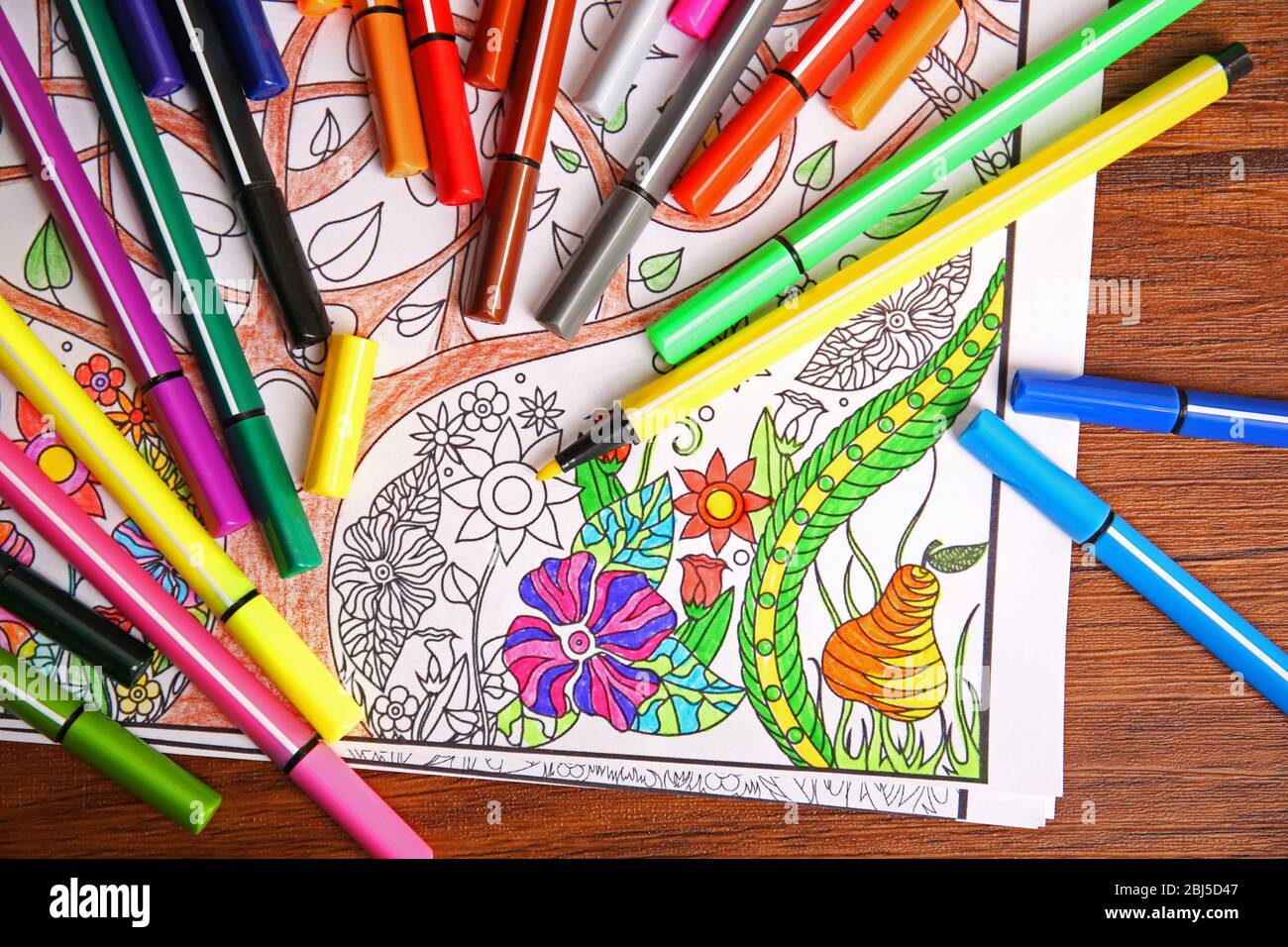 Coloured antistress book and soft tip pencils Stock Photo - Alamy