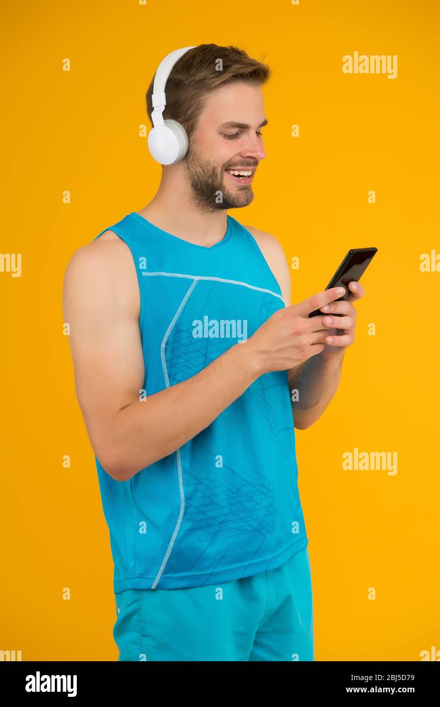Mobile device is your workout companion. Happy sportsman hold mobile ...