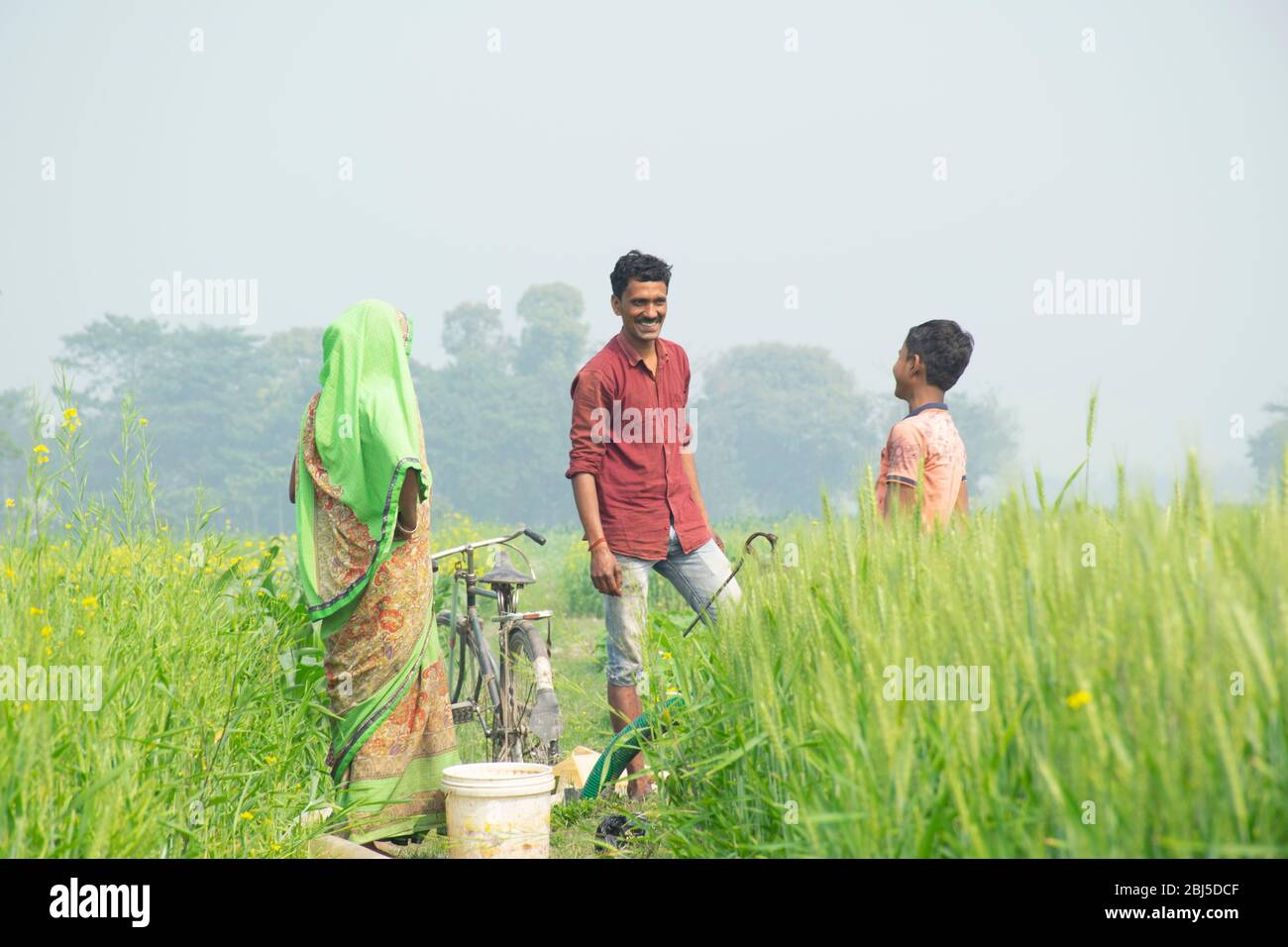happy farmer and his family doing agricultural work at farm Stock Photo ...