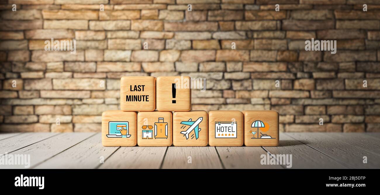 cubes with message LAST MINUTE and travel icons in front of a brick ...
