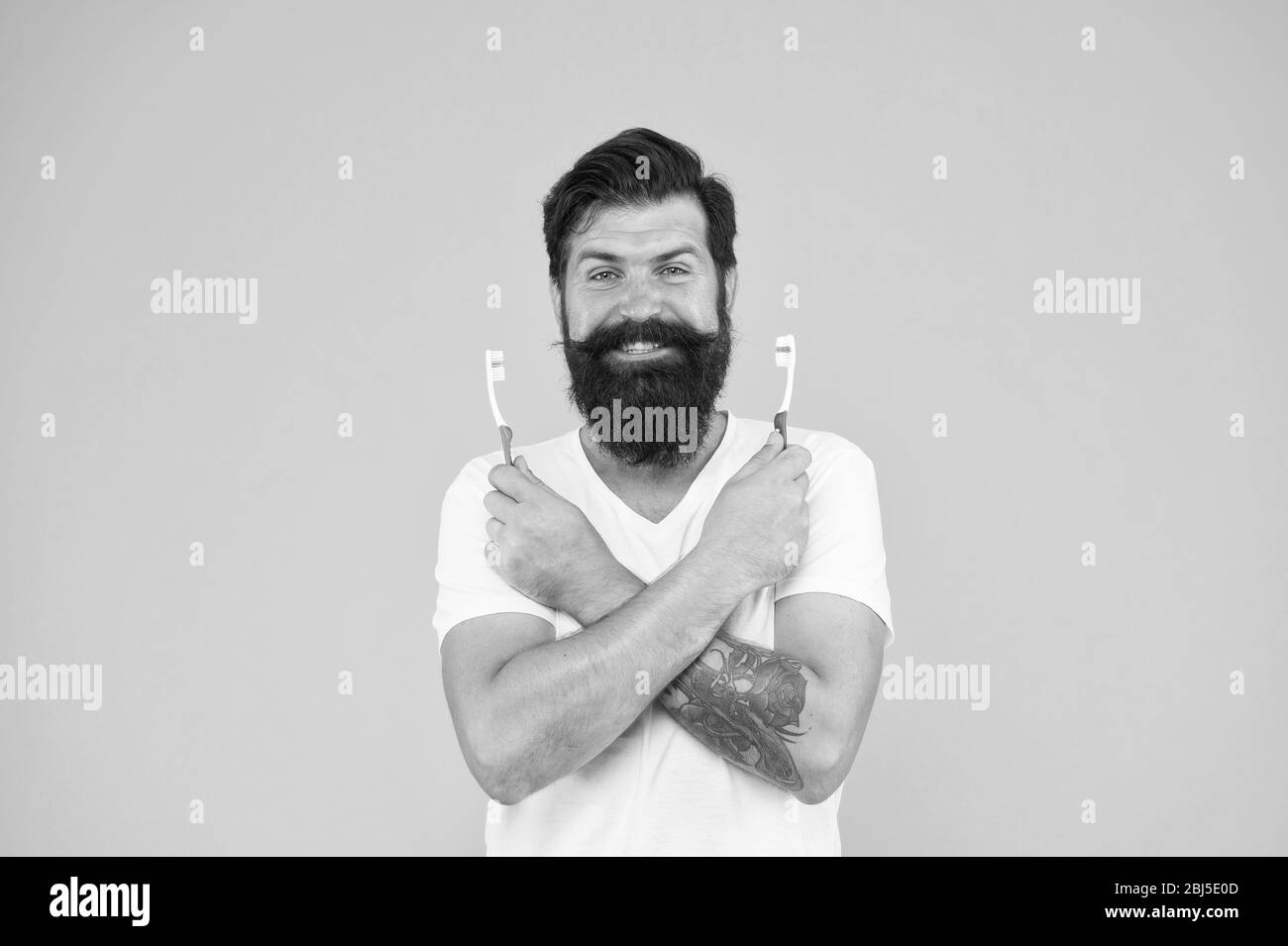 Personal hygiene routine. Happy man hold toothbrushes. Oral hygiene ...