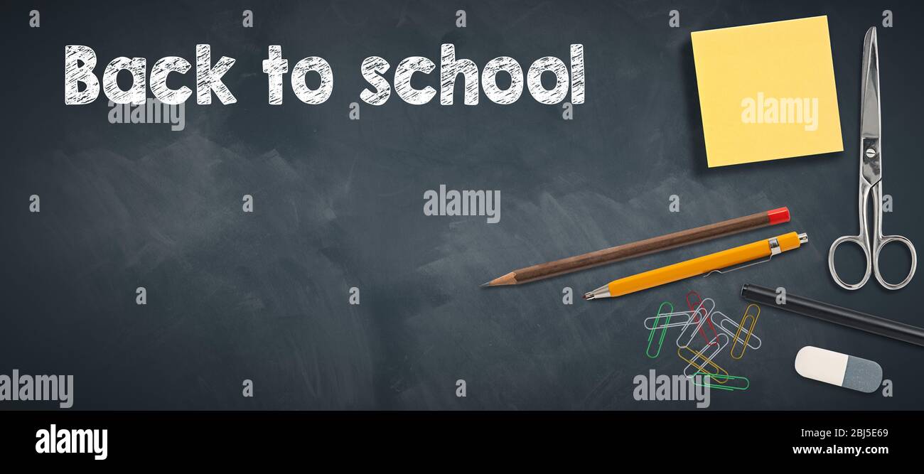 message BACK TO SCHOOL with sticky notes and pens on a blackboard Stock ...