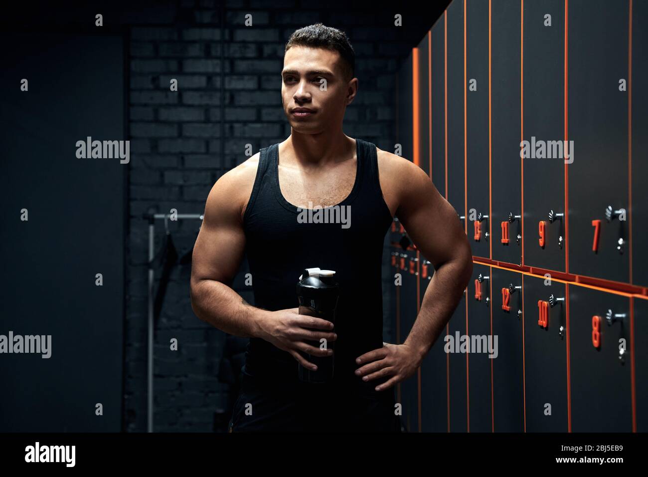 Sporty Lifestyle. Young fit man standing at locker room finished ...