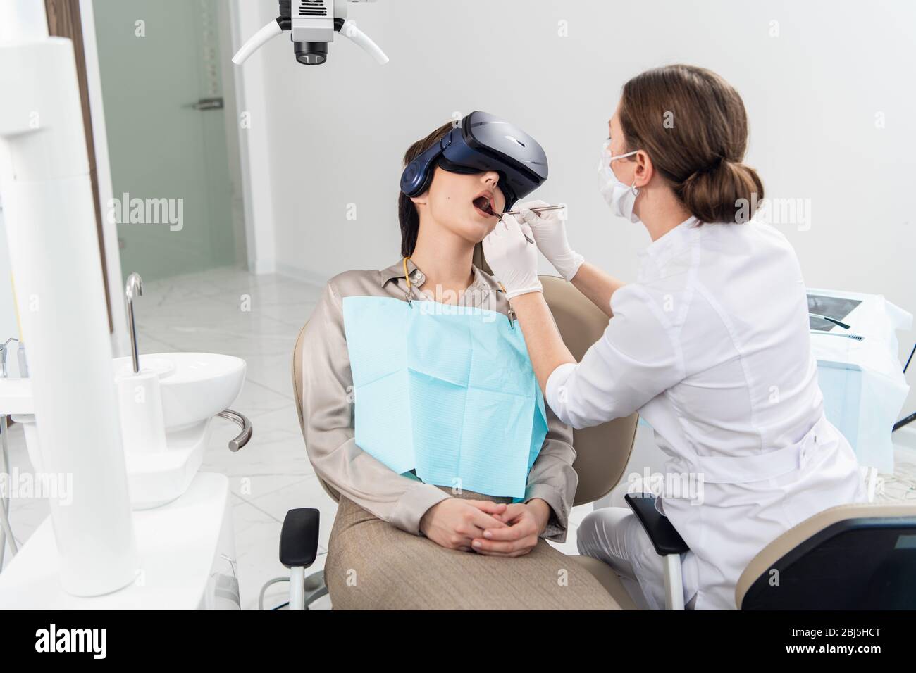 A procedure of drilling a tooth, setting a temporary seal Stock Photo ...