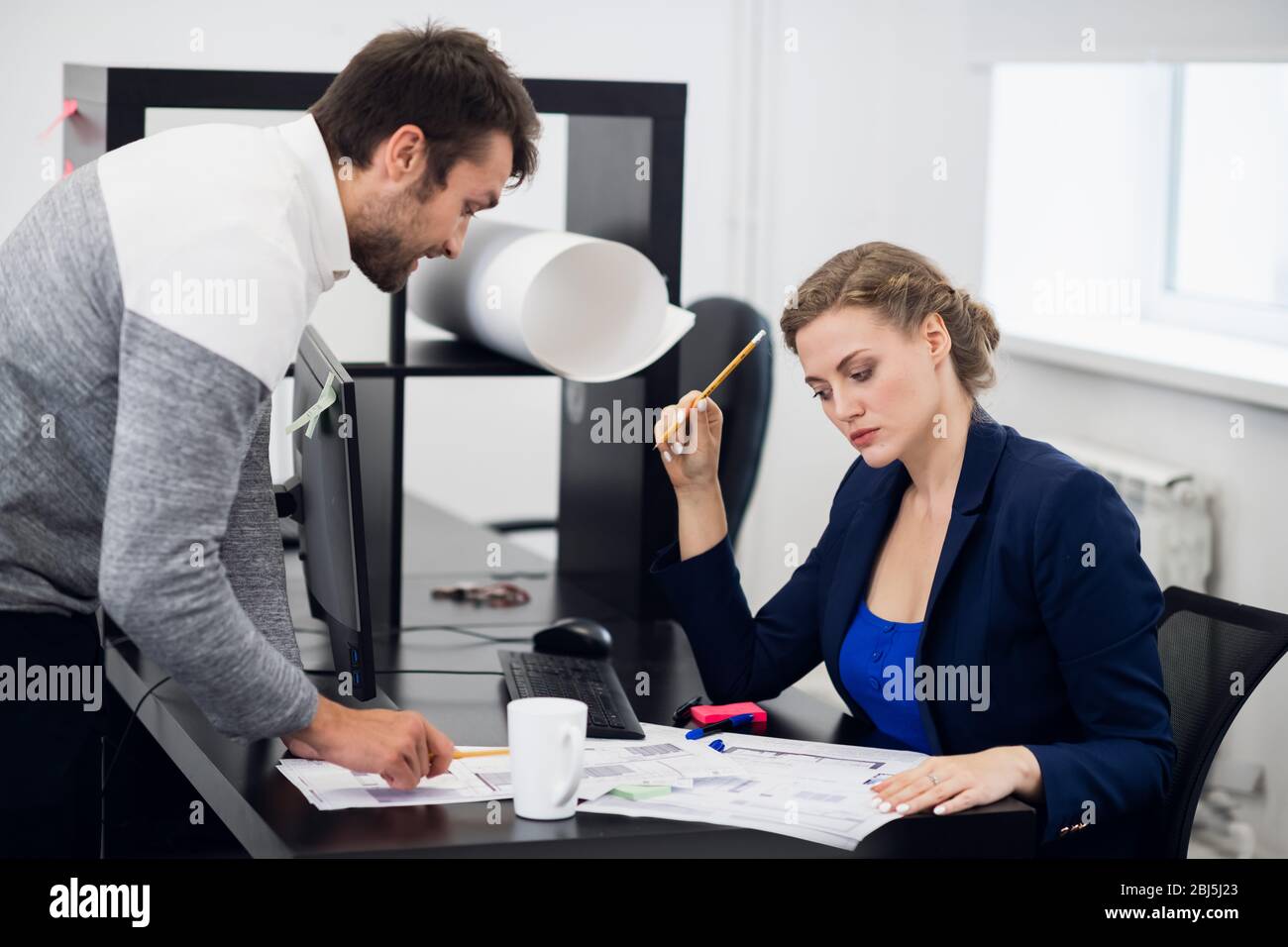 Office routine. Two office managers, a man and a woman, at work Stock ...