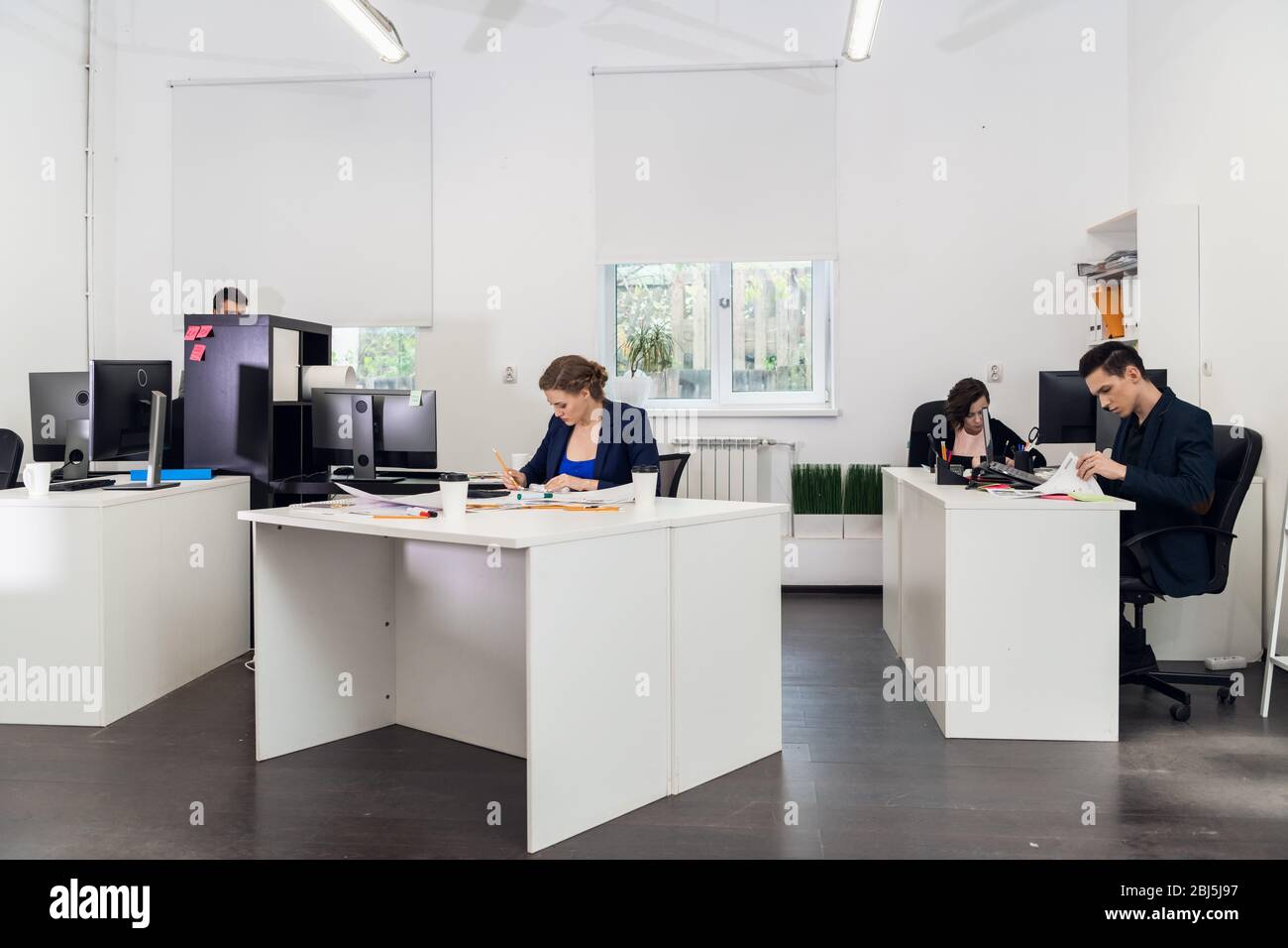 A busy workday in the modern office Stock Photo - Alamy