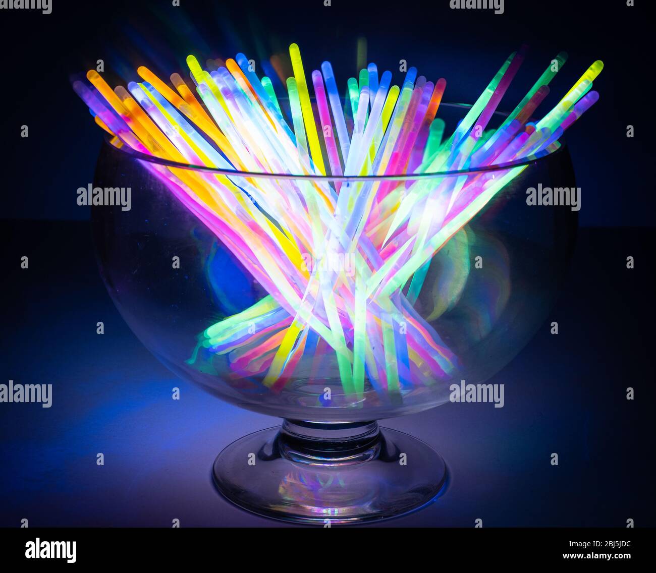 Glass bowl containing a large bunch of colourful glowsticks Stock Photo ...