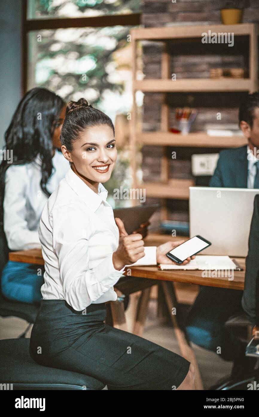 Charming Businesswoman Show Big Thumb In Approval Stock Photo - Alamy