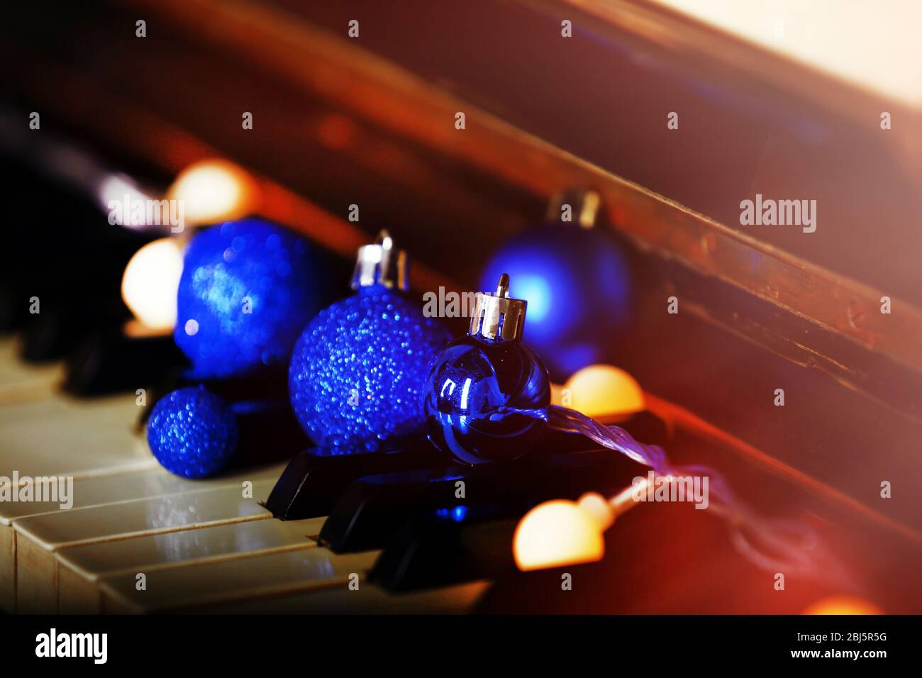 Piano keys decorated with decorative lights and balls, close up Stock ...